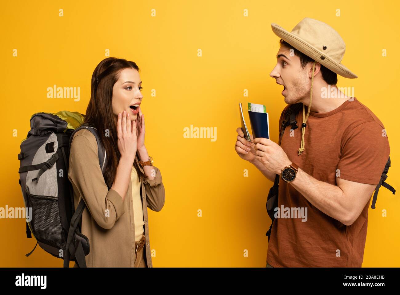 excited girlfriend with backpack and boyfriend holding passports and ...