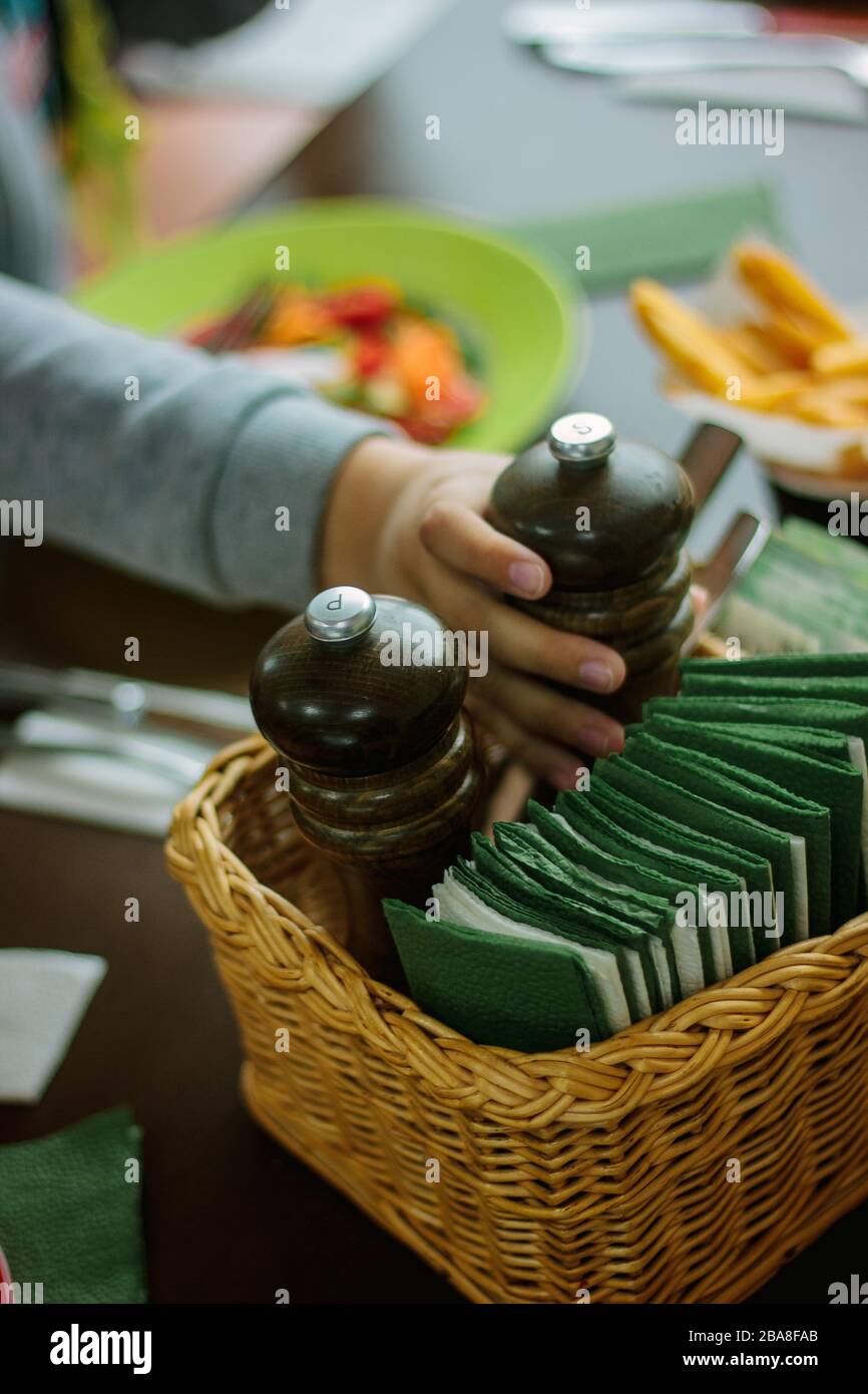 Kid hand and pepper grinder, great image for your needs Stock Photo - Alamy