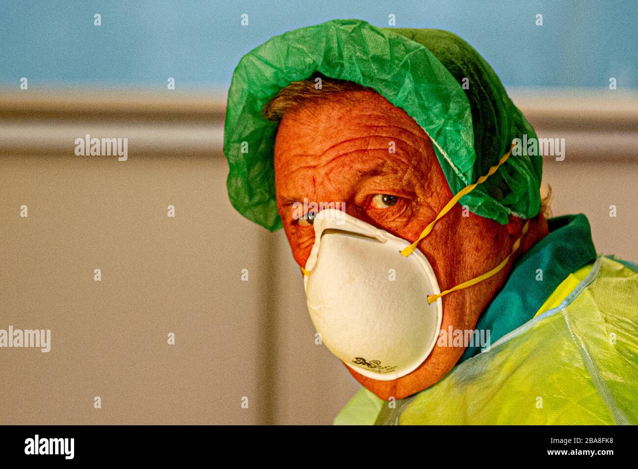 Breda, Netherlands. 21st Mar, 2020. A paramedic wears a mask as a ...