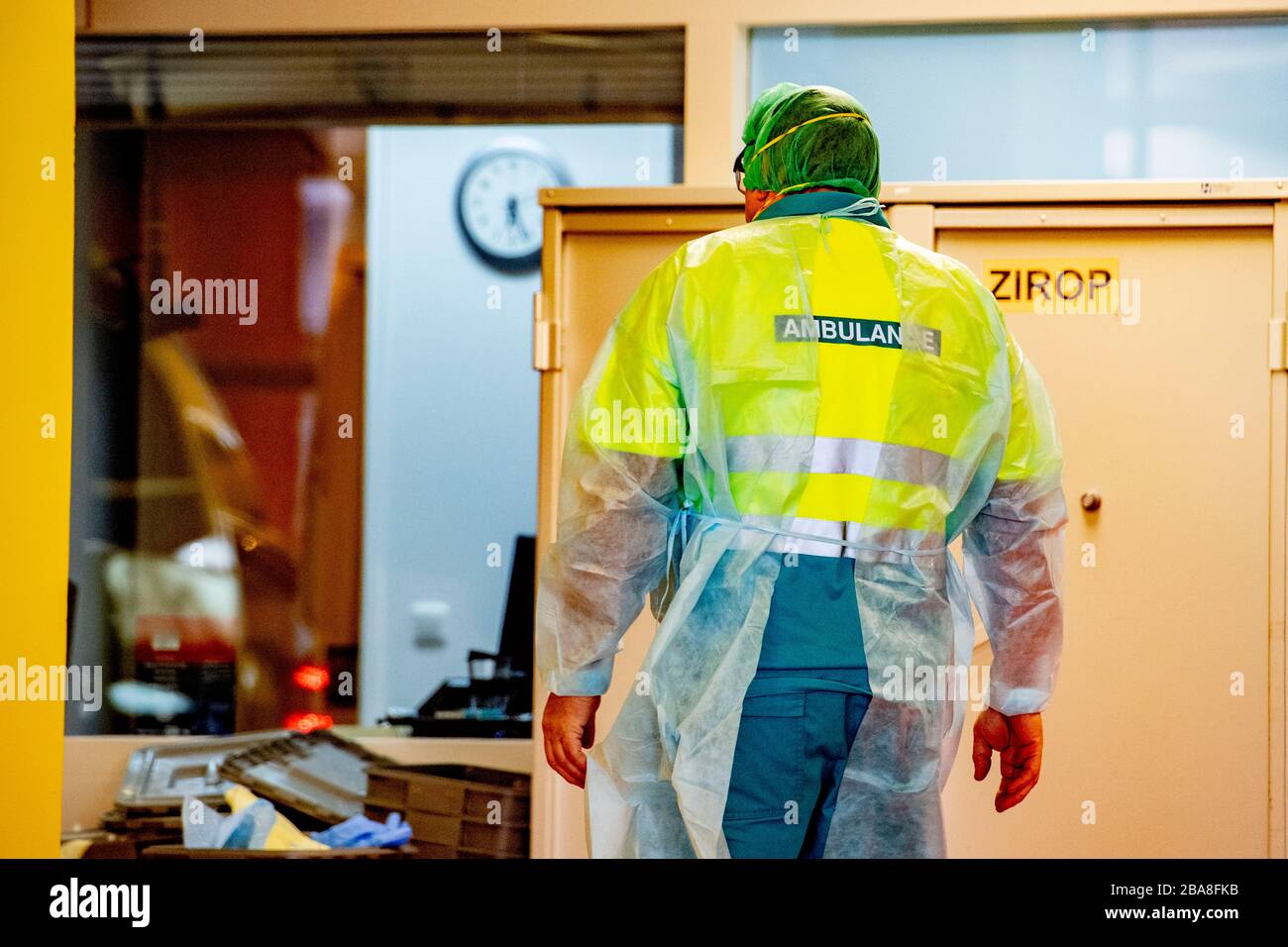 A paramedic wears a mask as a protective measure seen heading inside ...
