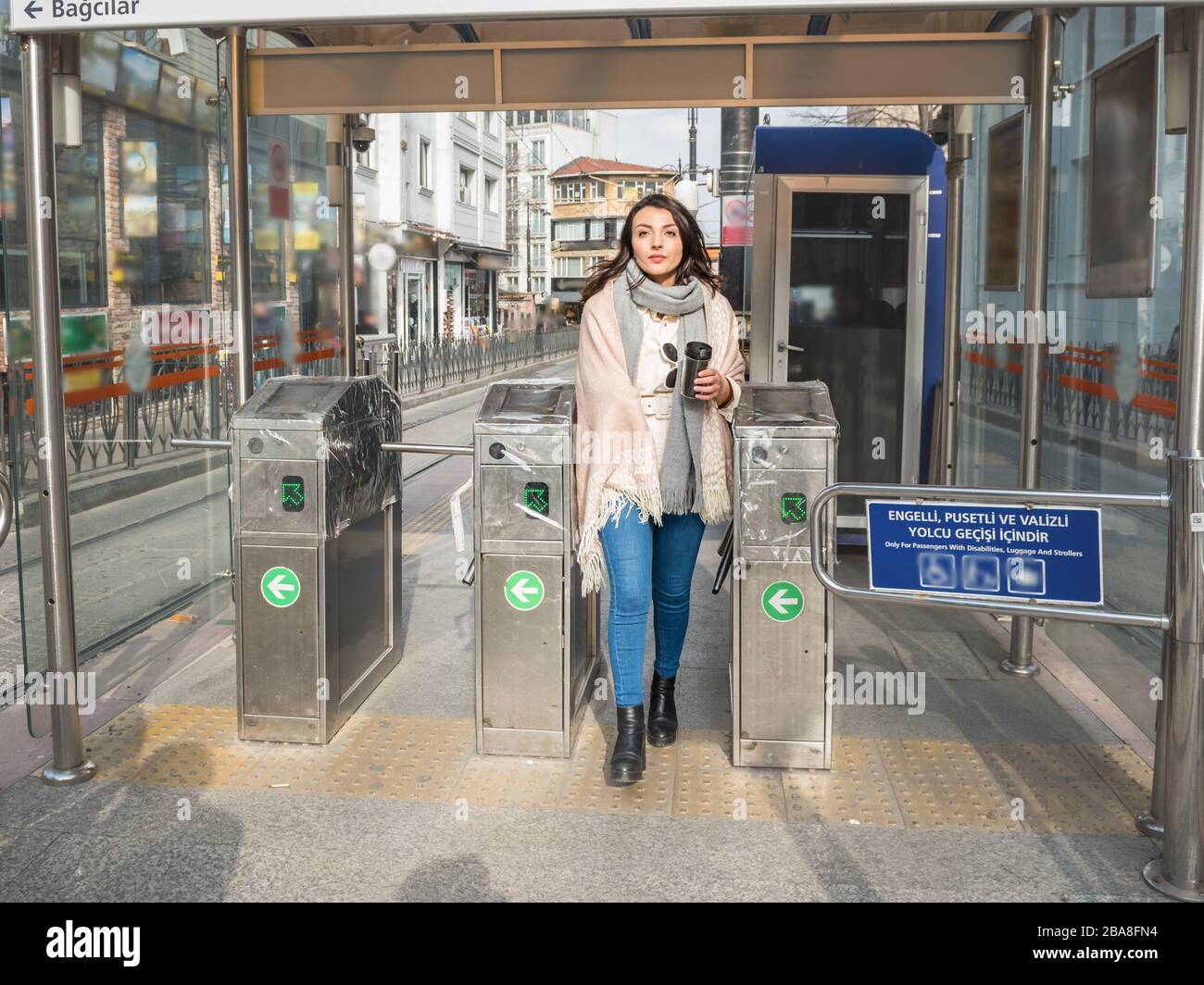 Beautiful young girl uses metrocard to pay the commuter fare and enter ...