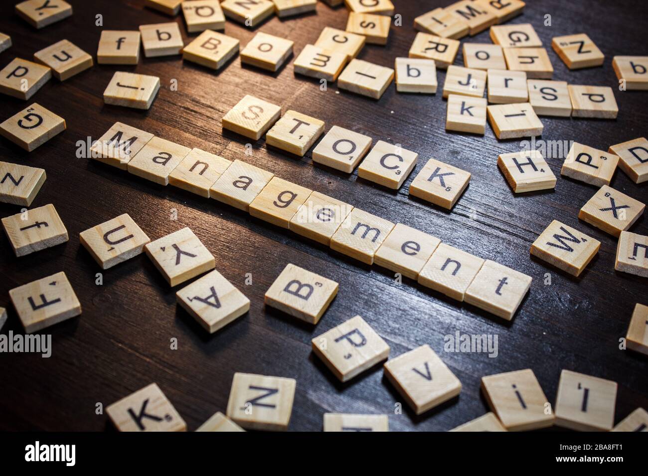 Word or phrase Stock Management made with scrabble letters on black ...