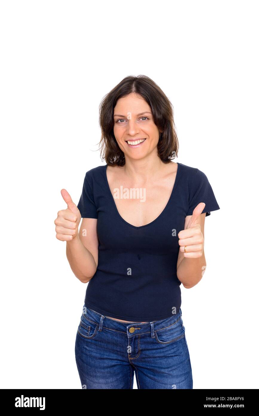 Studio shot of happy woman giving thumbs up isolated against white ...