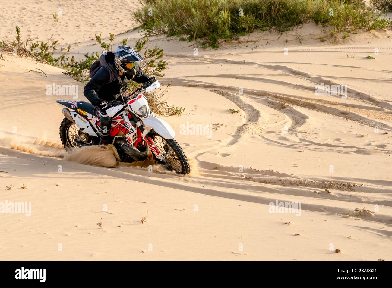 Dirt bike on a sand dune Stock Photo - Alamy