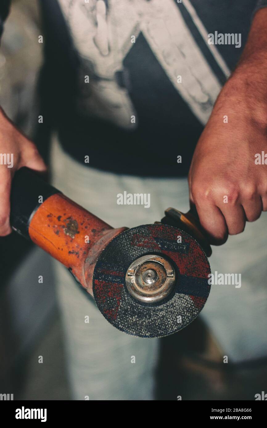 Angular grinding machine in a hands of carpenter. Great photo for your ...