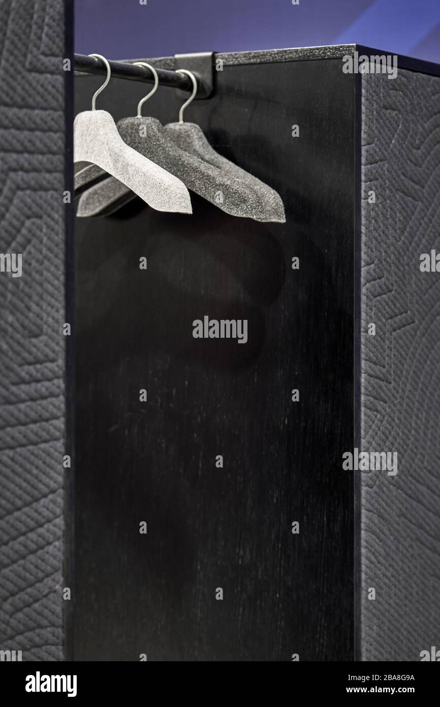Closeup view at hangers on rack in wardrobe Stock Photo - Alamy