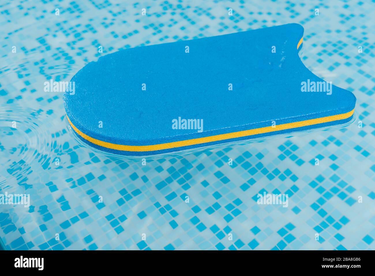 flutter board in swimming pool with blue water Stock Photo - Alamy