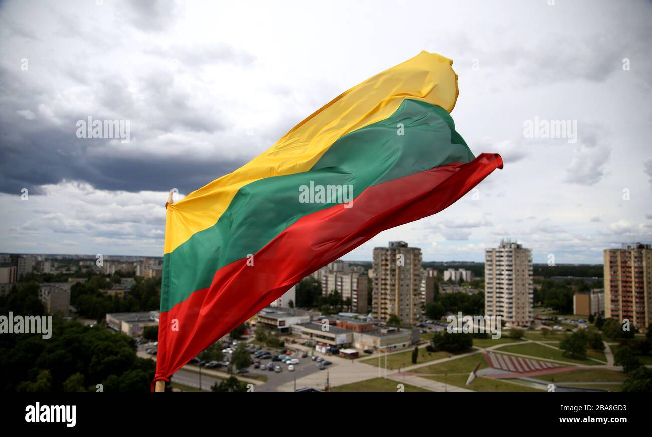 The Lithuanian flag is waving in tricolor over the city Stock Photo - Alamy