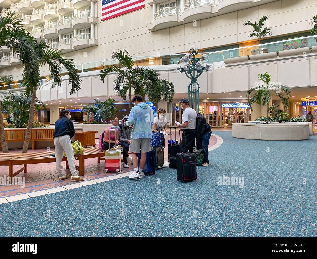 Orlando,FL/USA-3/21/20: People in masks waiting to go through Orlando ...