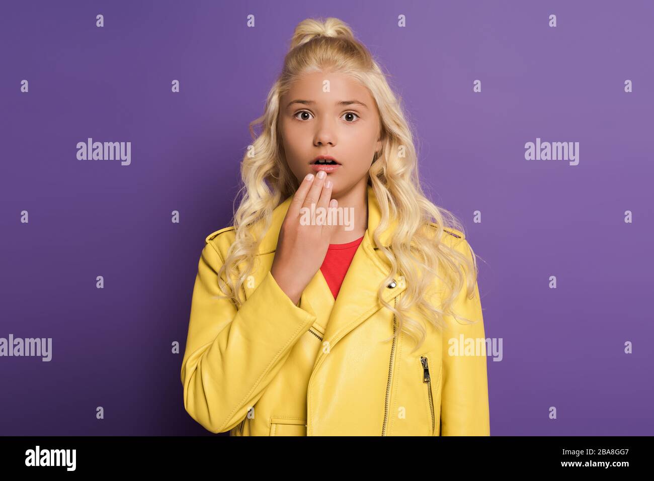shocked and cute kid looking at camera on purple background Stock Photo ...