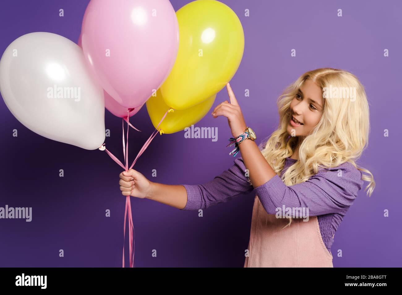 Child pointing pink balloon hi-res stock photography and images - Alamy
