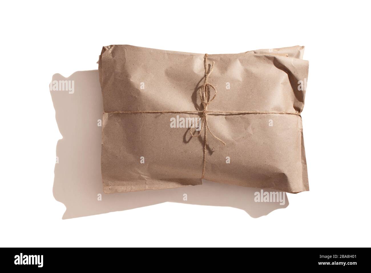 The parcel is wrapped with kraft paper and tied with a rope. Recyclable ...