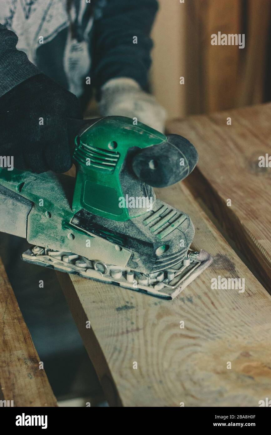 Carpenter grind the wood material with sander machine. Great photo for ...