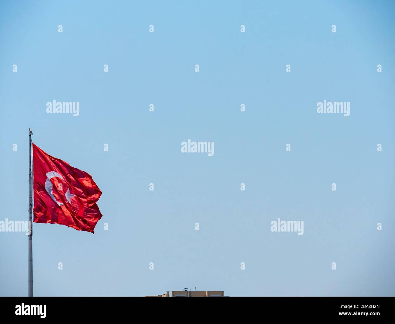 Turkish flag waving front of blue sky. Background Stock Photo - Alamy