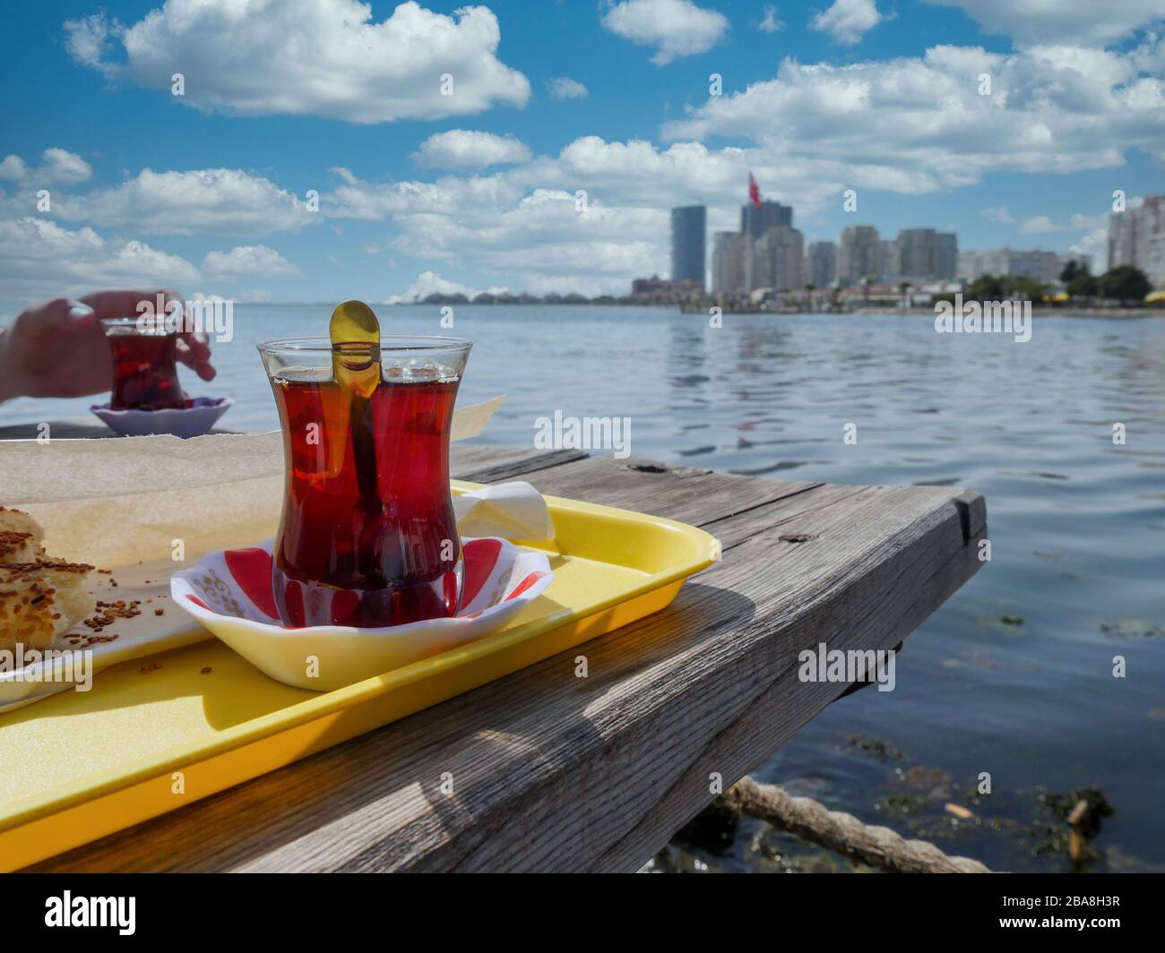Drinking traditional turkish tea in the glass near seaside of izmir ...