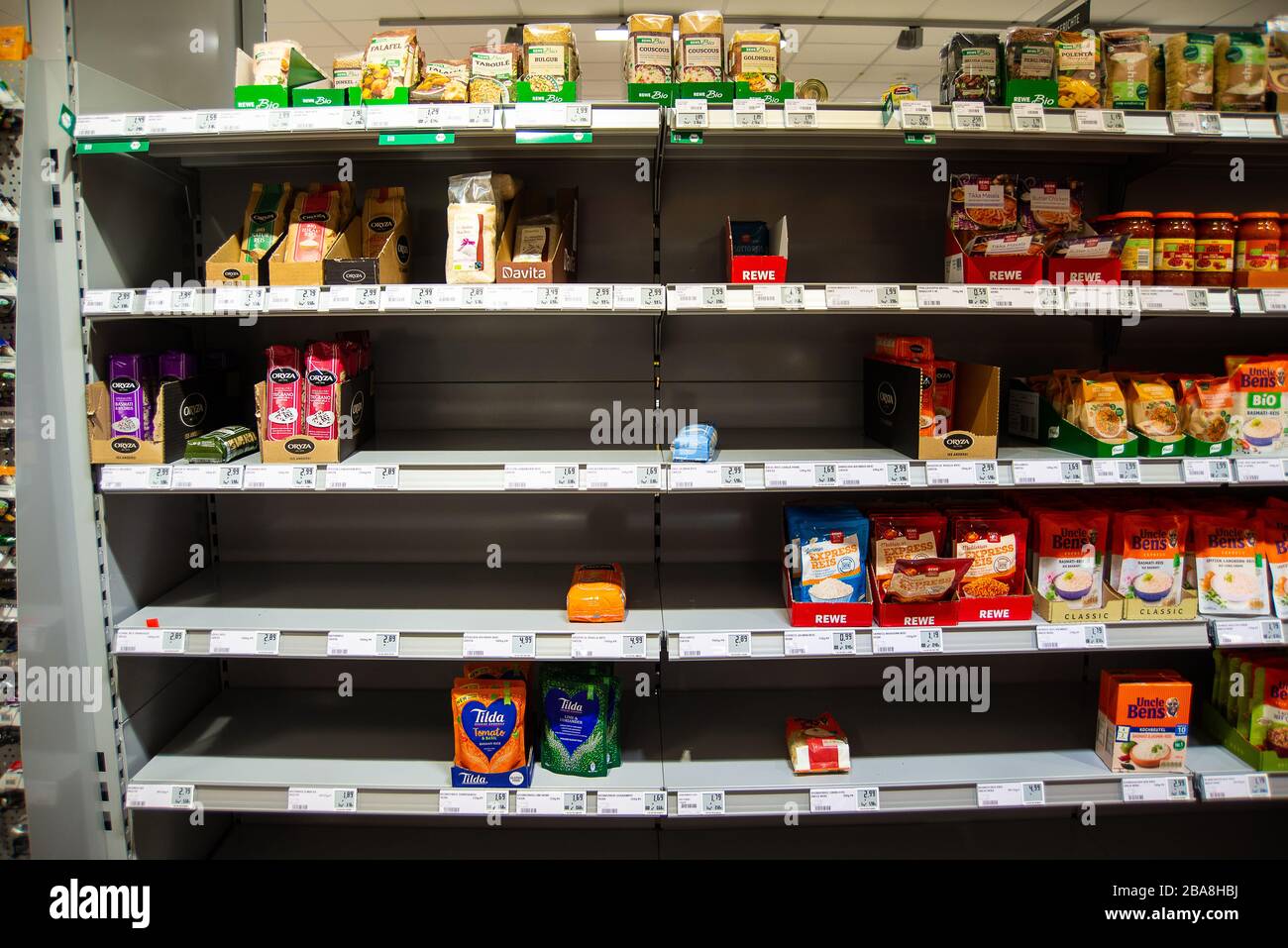 Neuoetting,Germany-March 18,2020: Half empty rice shelves in a ...