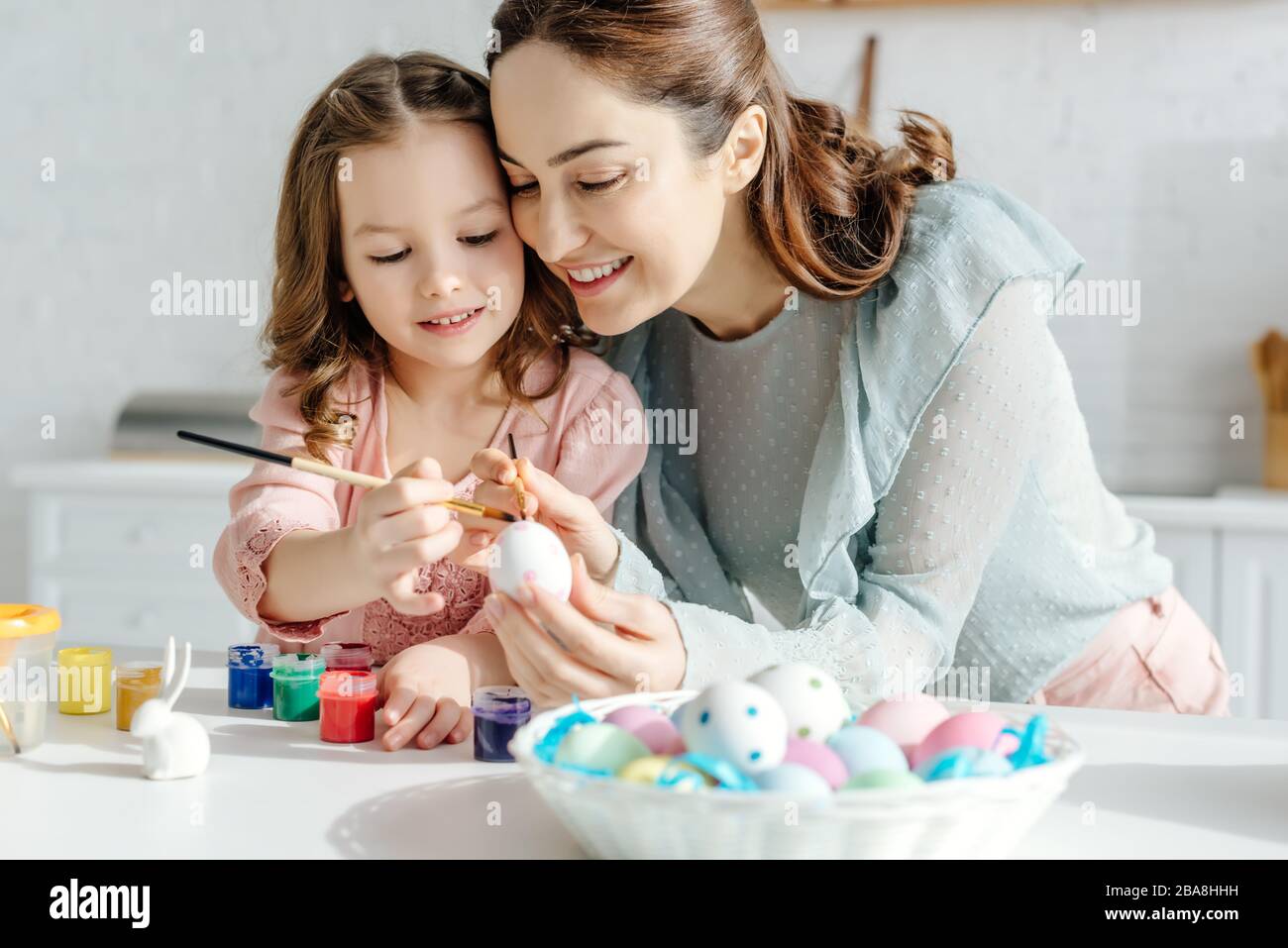 selective focus of happy mother and daughter painting chicken egg Stock ...
