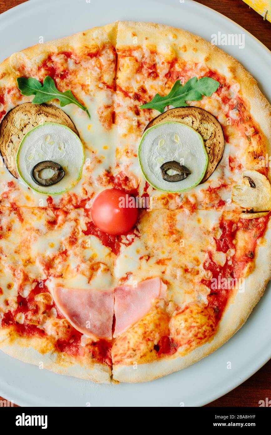 Top view of pizza for kids in a form of funny face, great image for ...