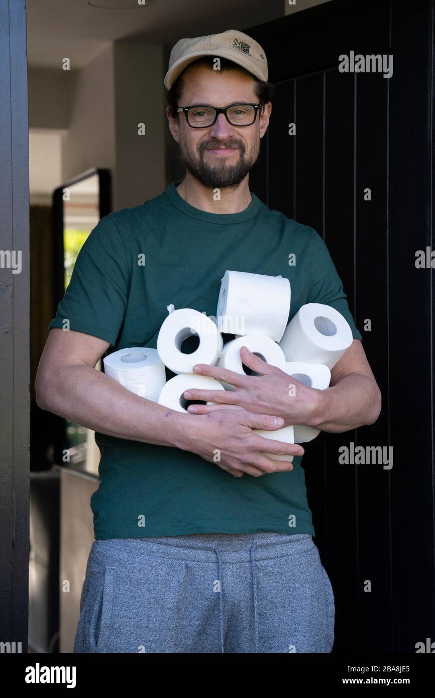 Man hoarding toilet roll during Coronavirus pandemic panic buying Stock ...
