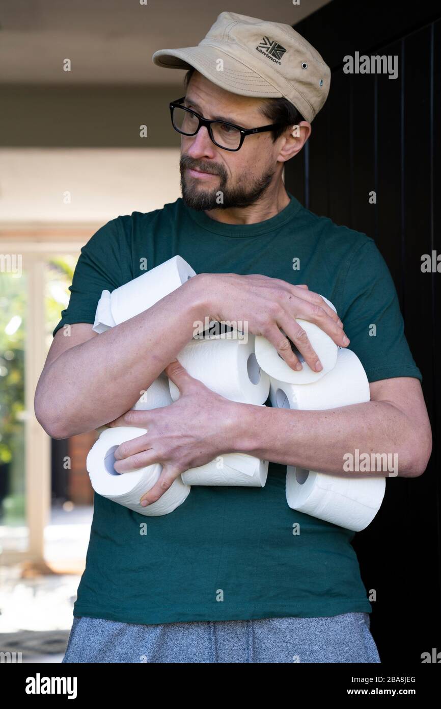 Man hoarding toilet roll during Coronavirus pandemic panic buying Stock ...