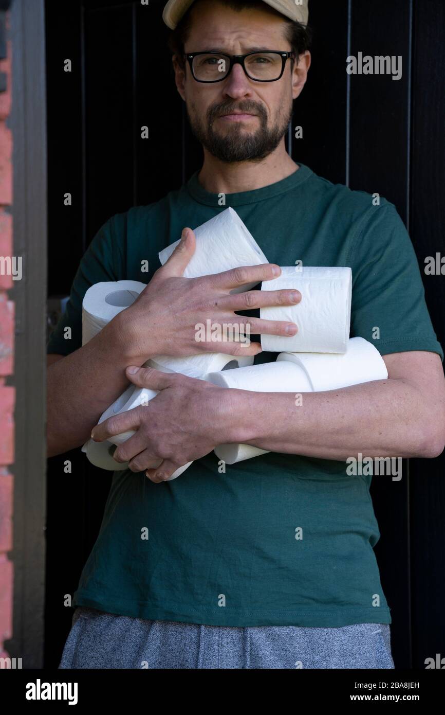 Man hoarding toilet roll during Coronavirus pandemic panic buying Stock ...