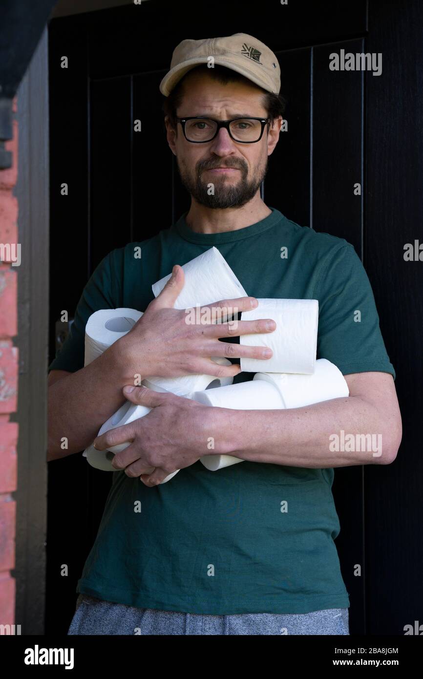 Man hoarding toilet roll during Coronavirus pandemic panic buying Stock ...