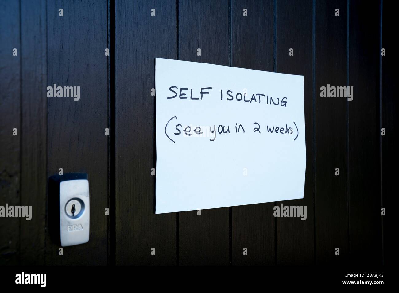 Handwritten self Isolation notice on black front door due to ...