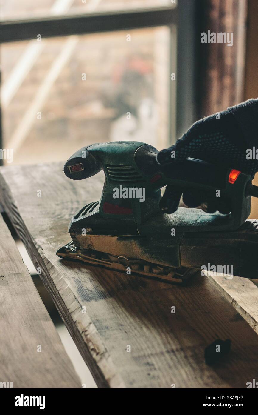 Carpenter grind the wood material with sander machine. Great photo for ...