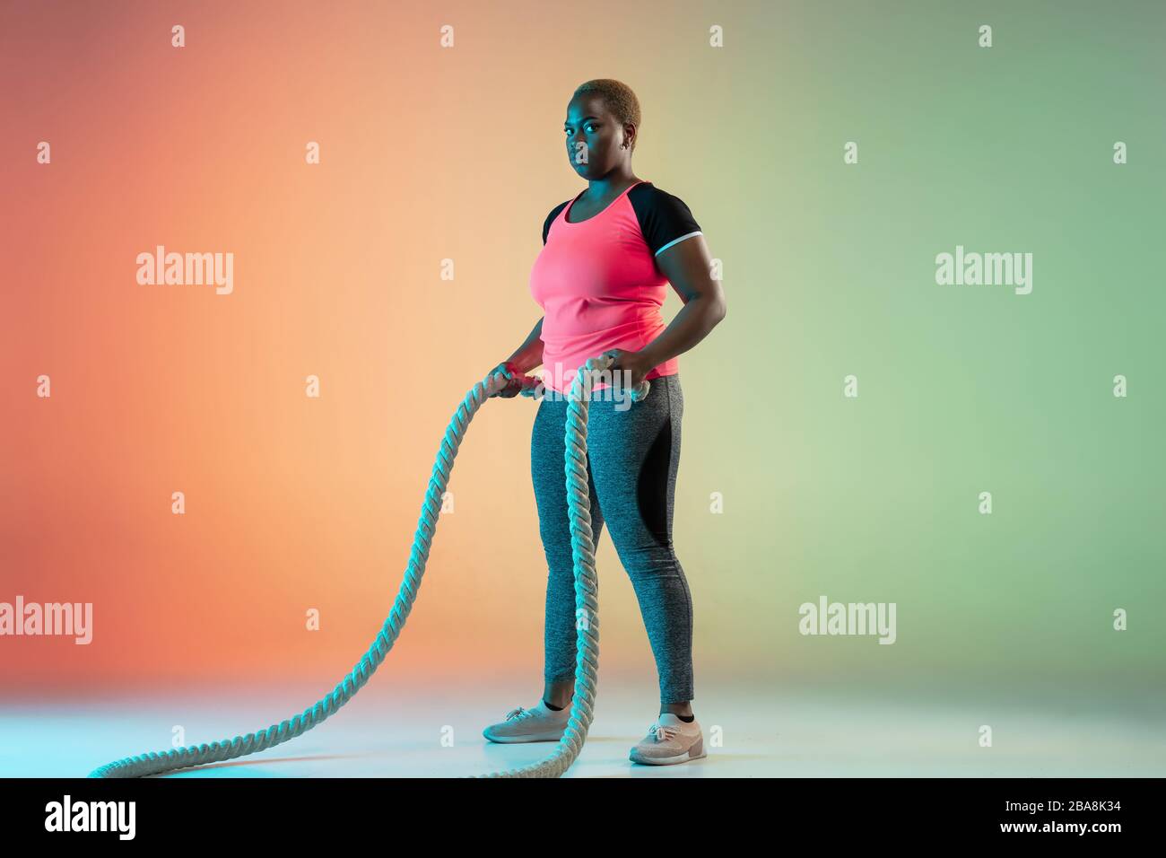 Young african-american plus size female model's training on gradient ...