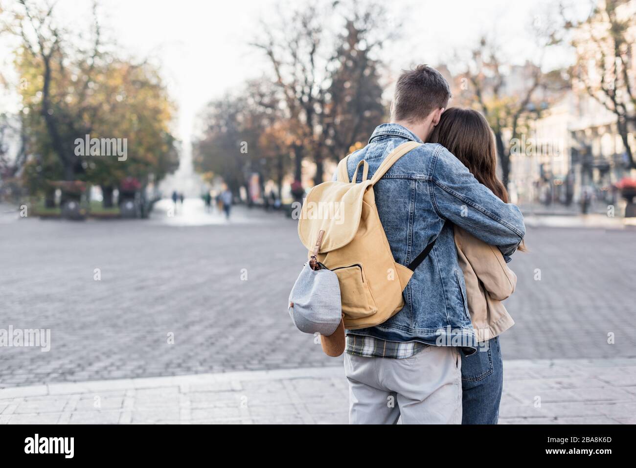 Man with backpack hugging with girlfriend in Europe Stock Photo - Alamy