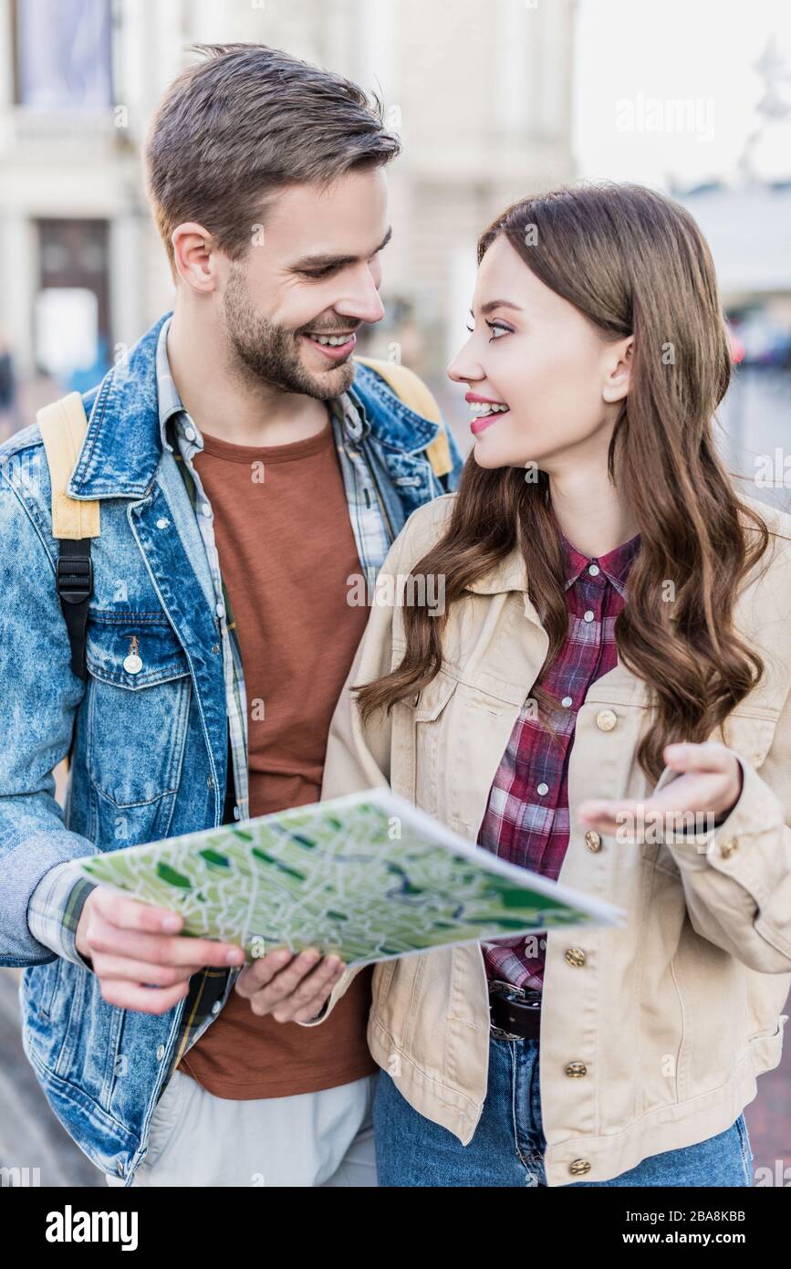 Selective focus of boyfriend and girlfriend looking at each other ...