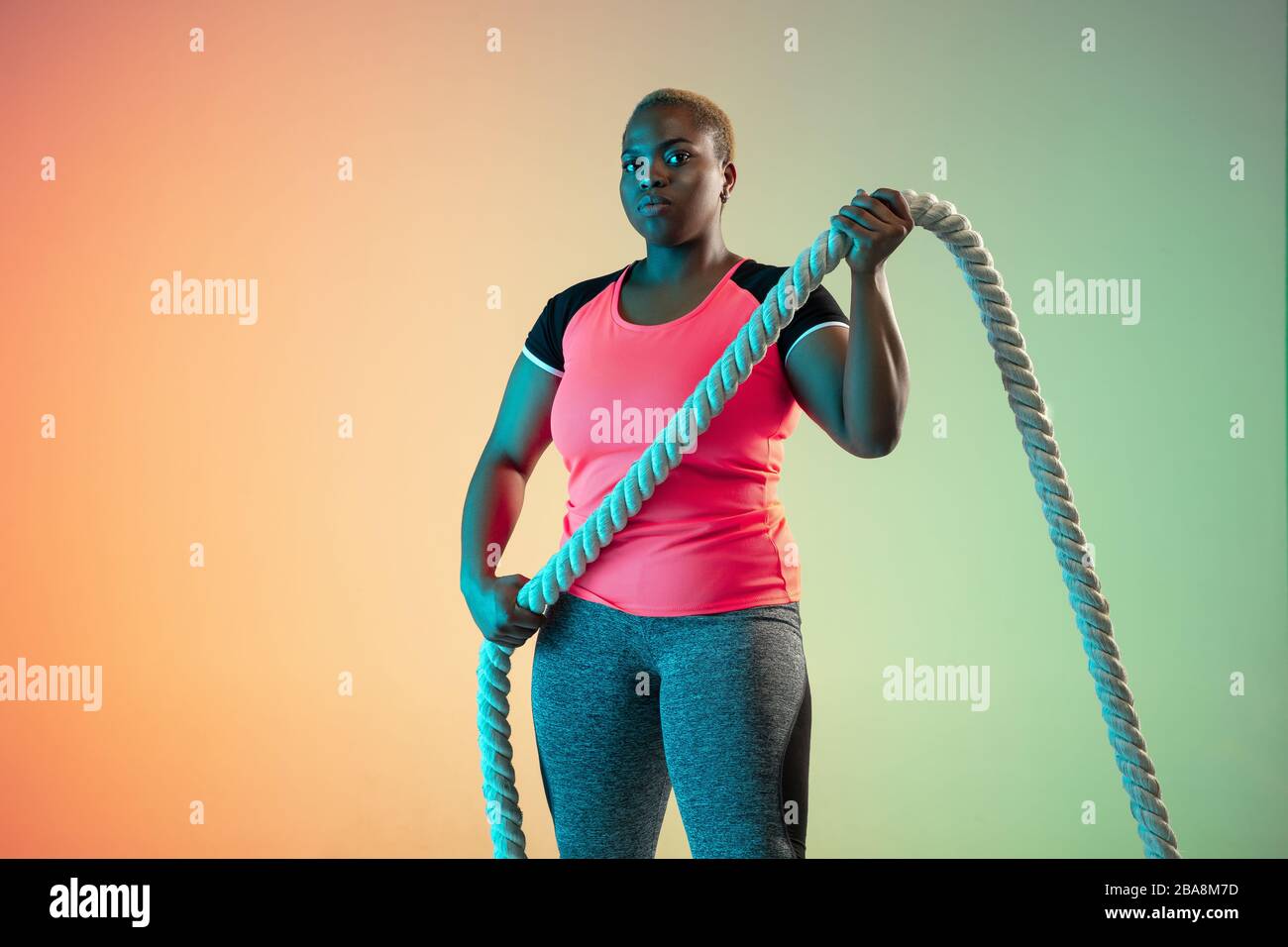 Young african-american plus size female model's training on gradient ...