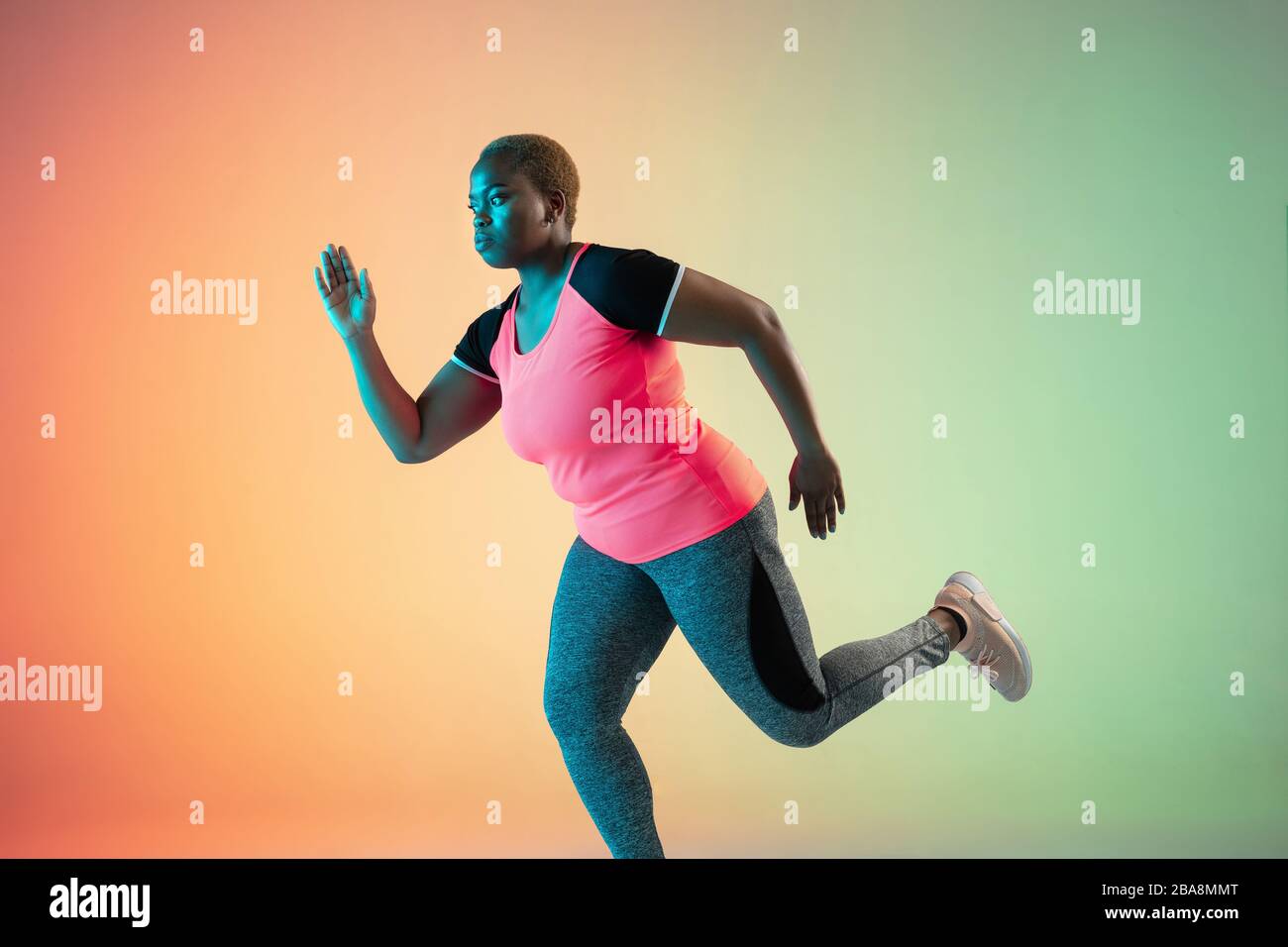 Young african-american plus size female model's training on gradient ...