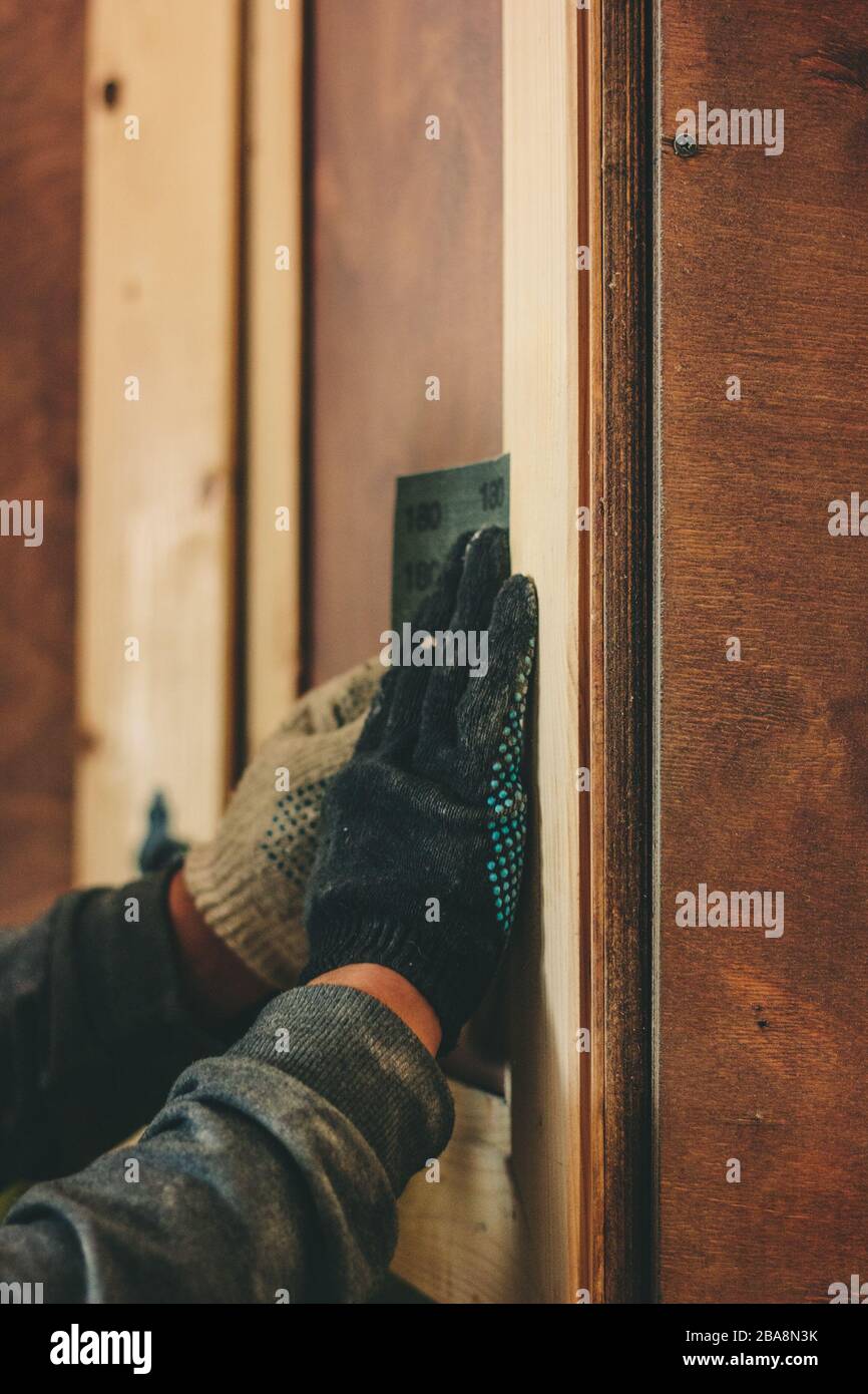 Hands treating wood surface with sandpaper. Great photo for your needs ...