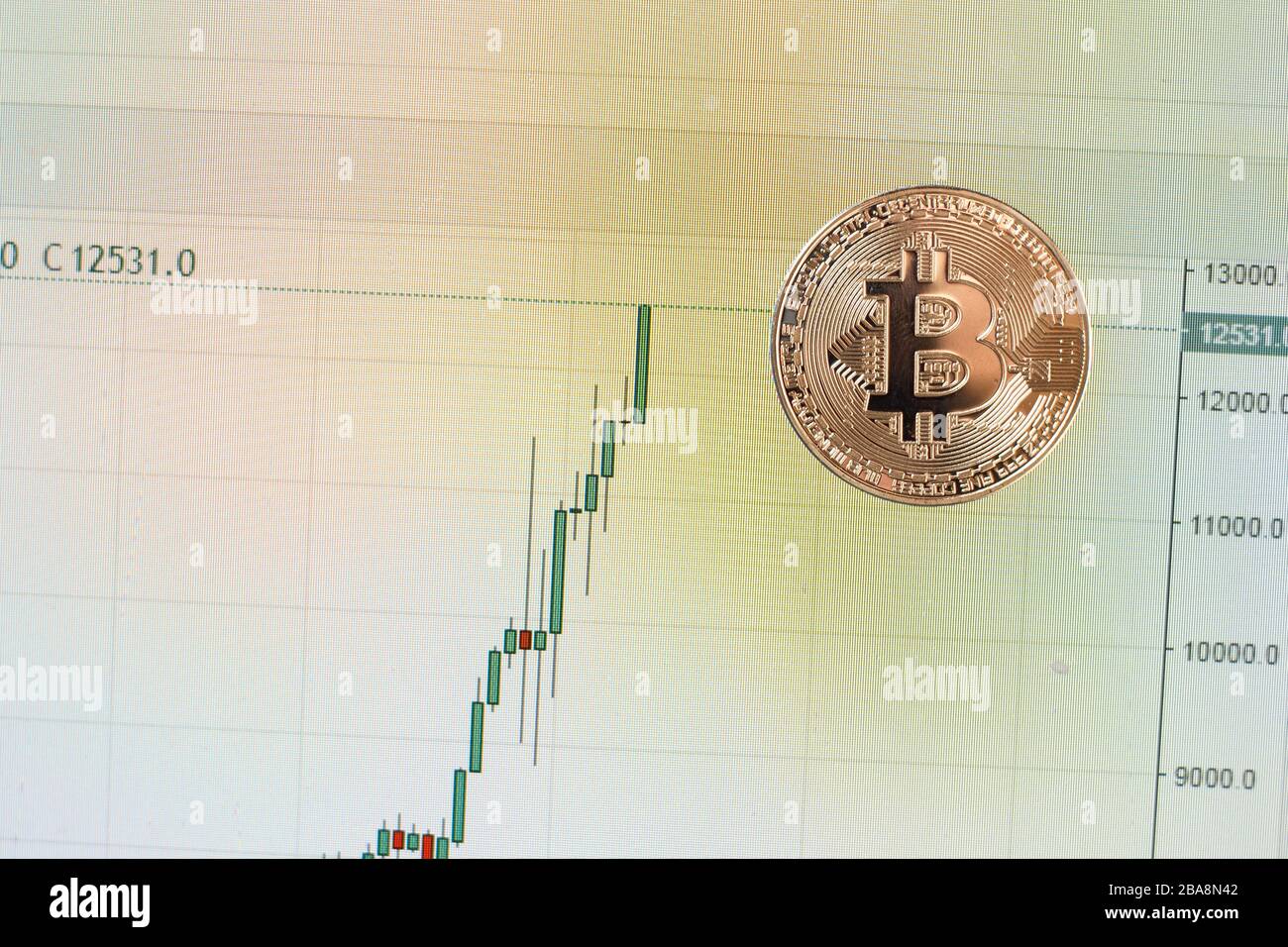 Golden bitcoin coin on a chart of currency growth Stock Photo - Alamy