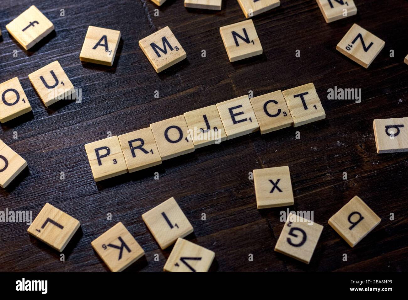 Project word made with scrabble letters on a black wooden table Stock ...