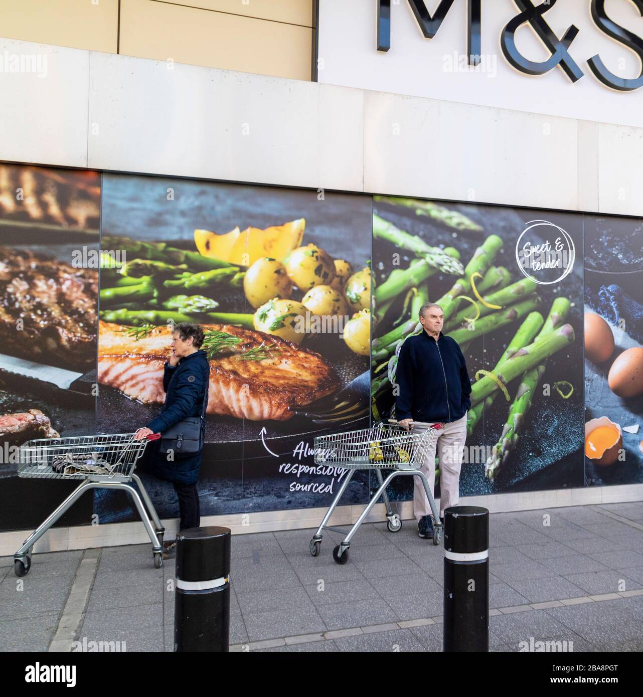 Men queuing to enter grocery hi-res stock photography and images - Alamy