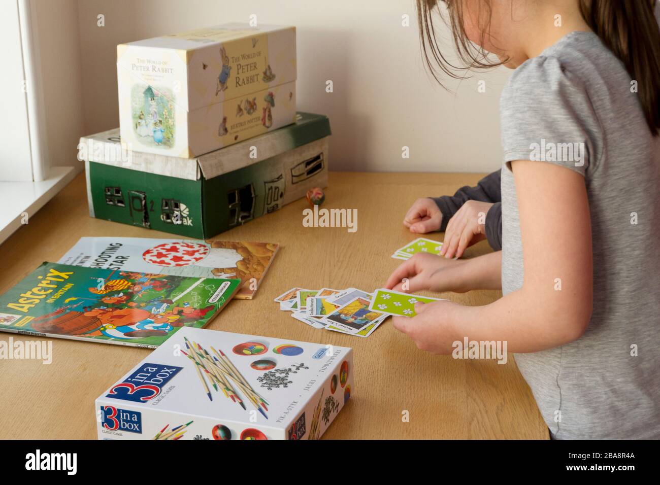 Children playing cards hi-res stock photography and images - Alamy
