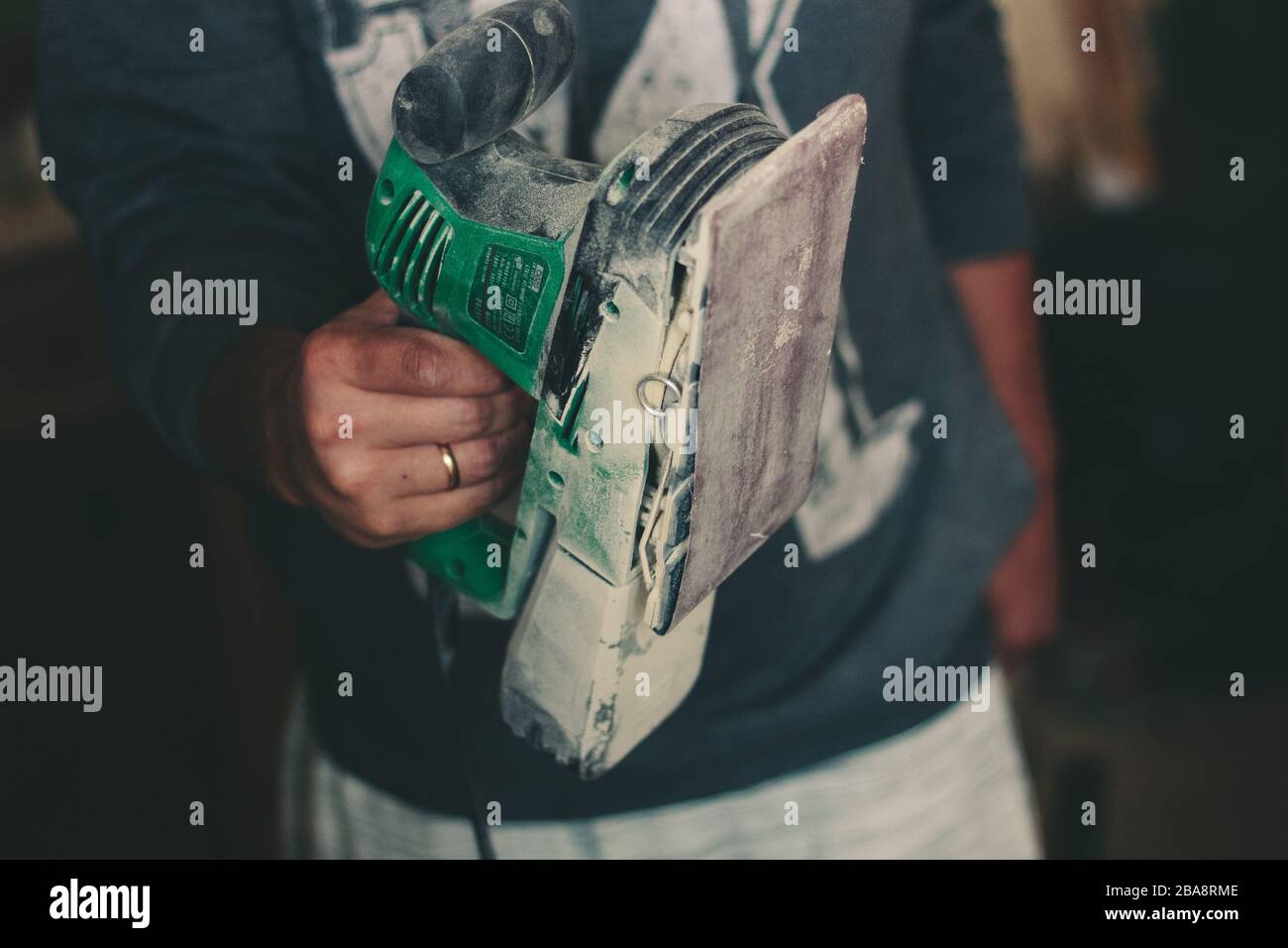 Electric sandpaper tool in a hand of carpenter. Great photo for your ...