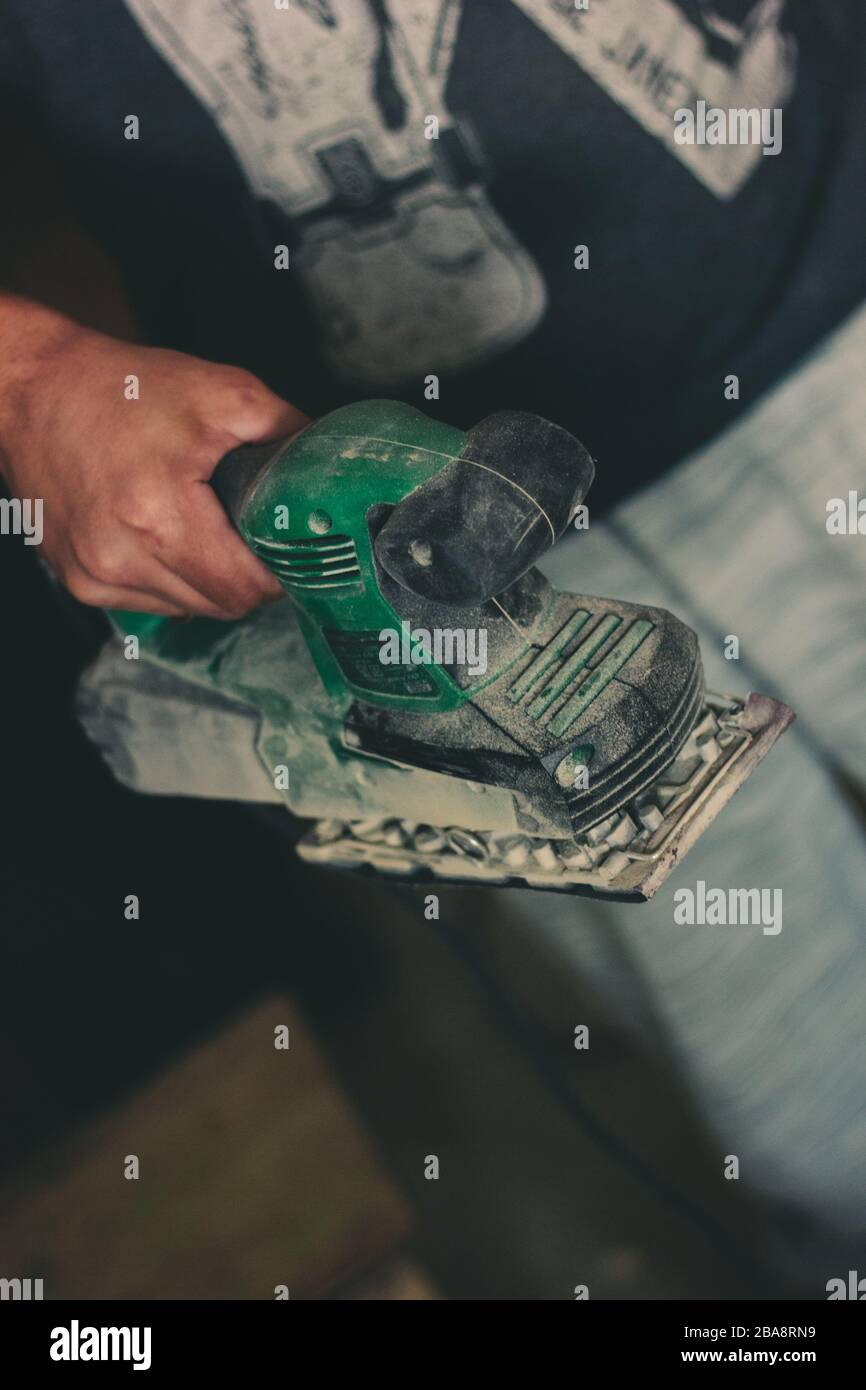 Electric sandpaper tool in a hand of carpenter. Great photo for your ...