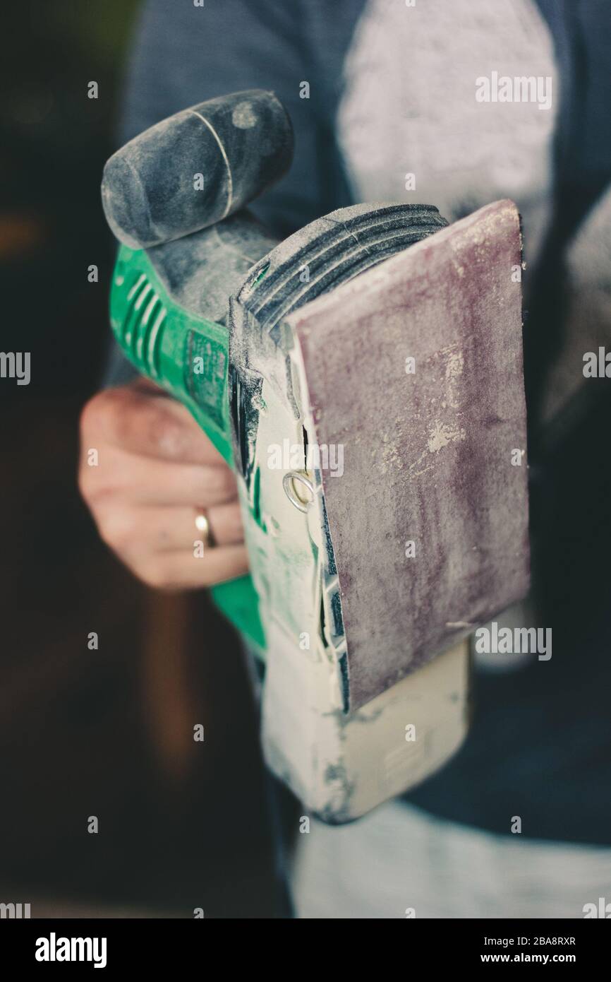 Electric sandpaper tool in a hand of carpenter. Great photo for your ...