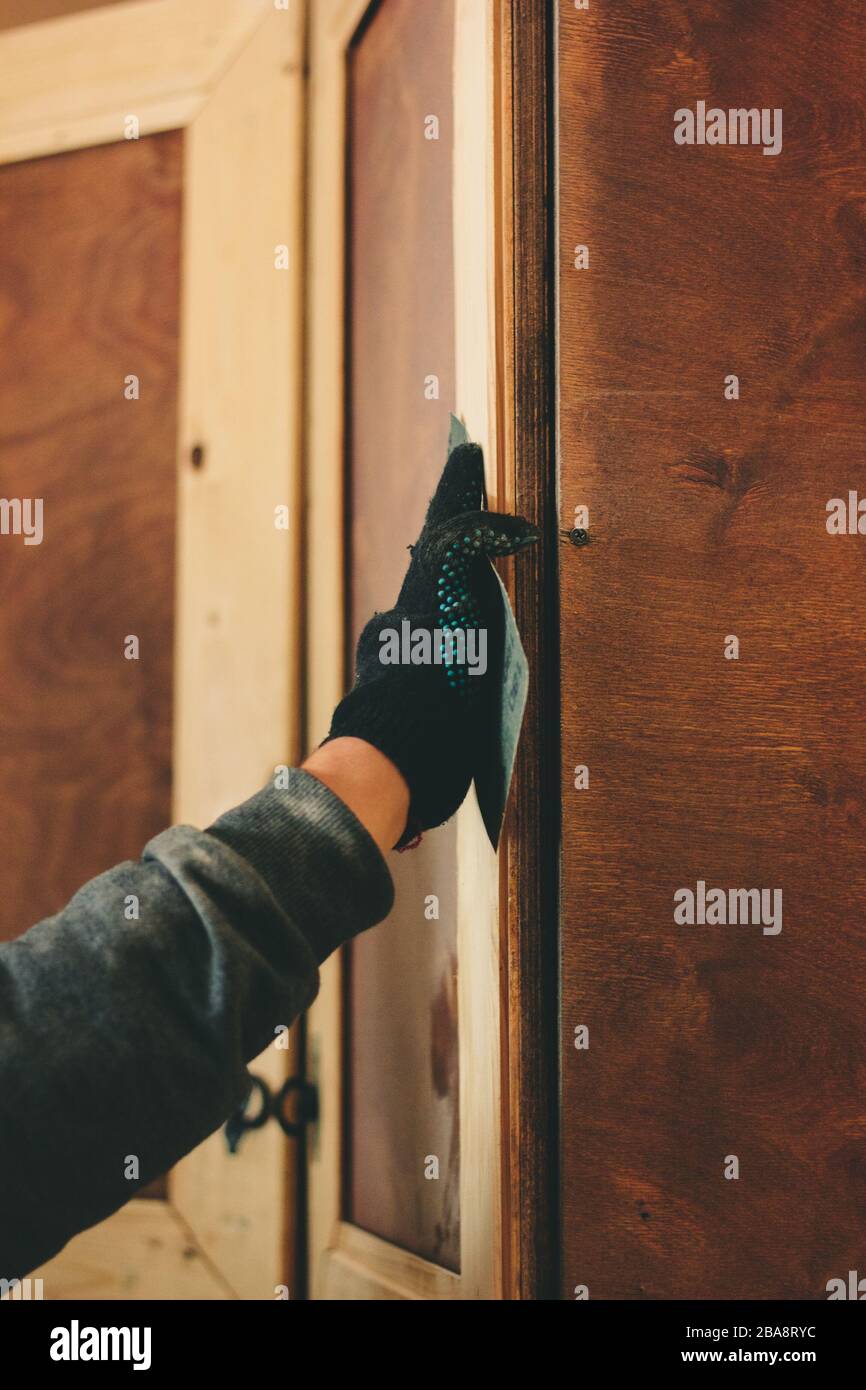 Hands treating wood surface with sandpaper. Great photo for your needs ...