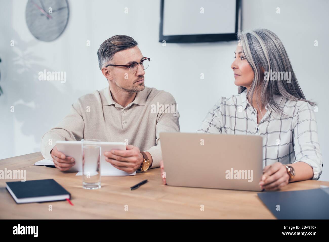 multicultural colleagues looking at each other in creative agency Stock ...