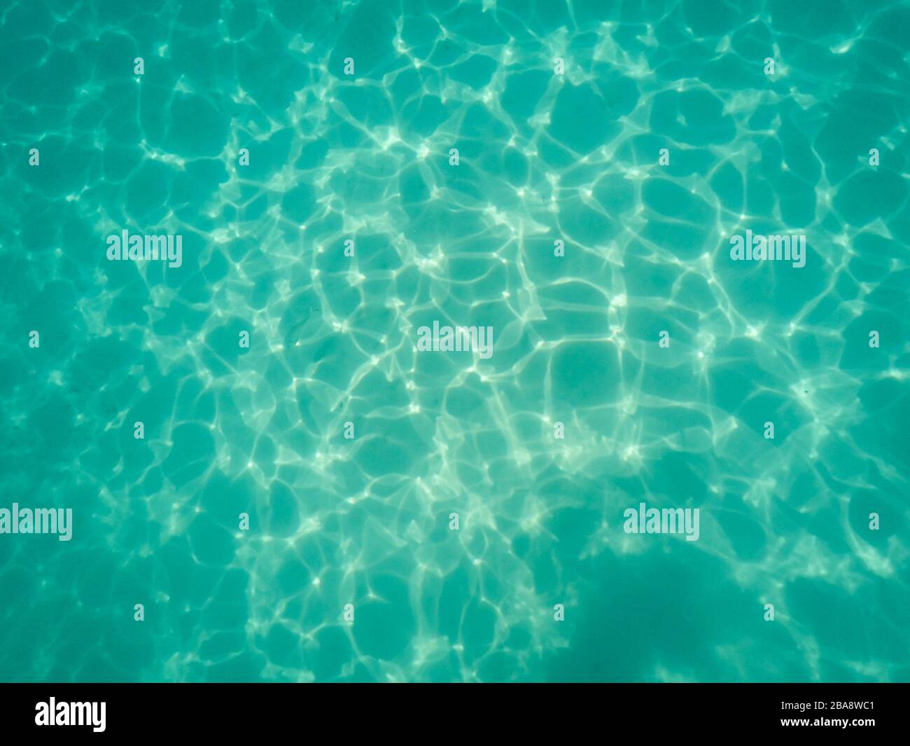 Ripples or reflections of sunlight underwater on sandy shallow ocean ...