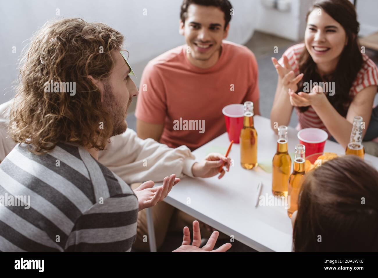 selective focus of man with sticky note on forehead playing name game ...