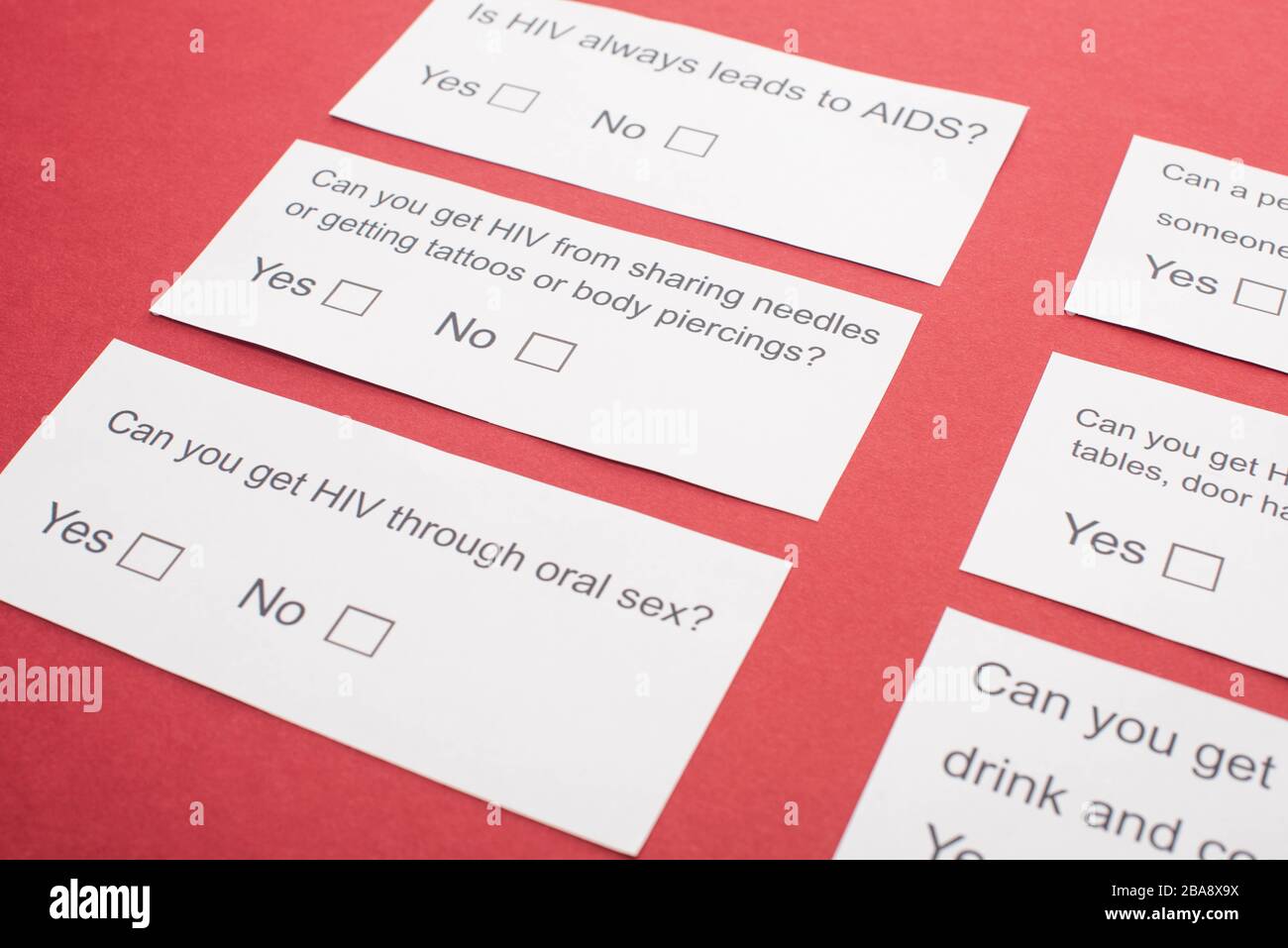paper cards with HIV questionnaire on red background Stock Photo - Alamy