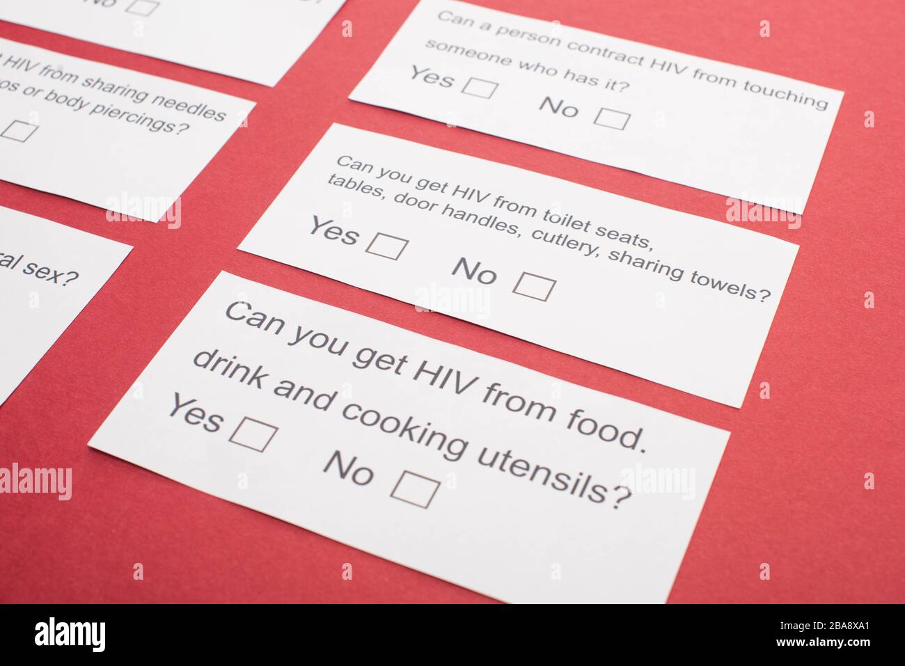 paper cards with HIV questionnaire on red background Stock Photo - Alamy