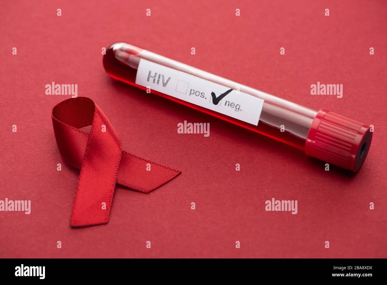 red awareness aids ribbon and negative hiv blood sample test on red ...