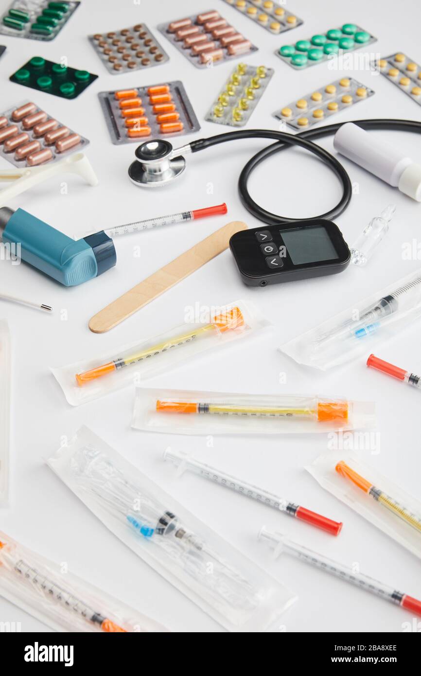 High angle view of colorful medicines, syringes and medical objects on ...