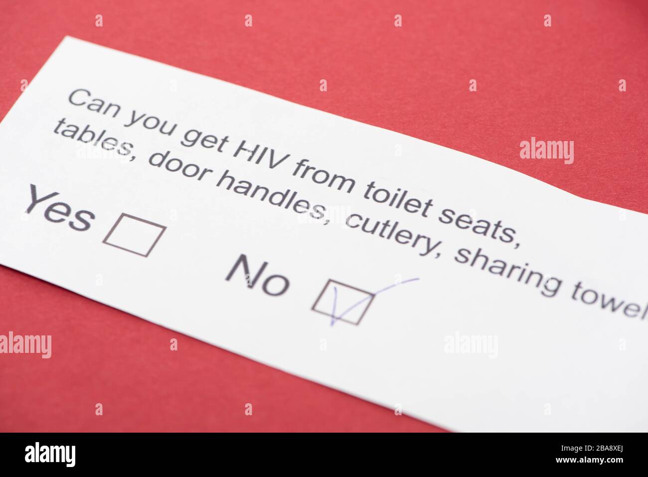 paper card with HIV questionnaire on red background Stock Photo - Alamy
